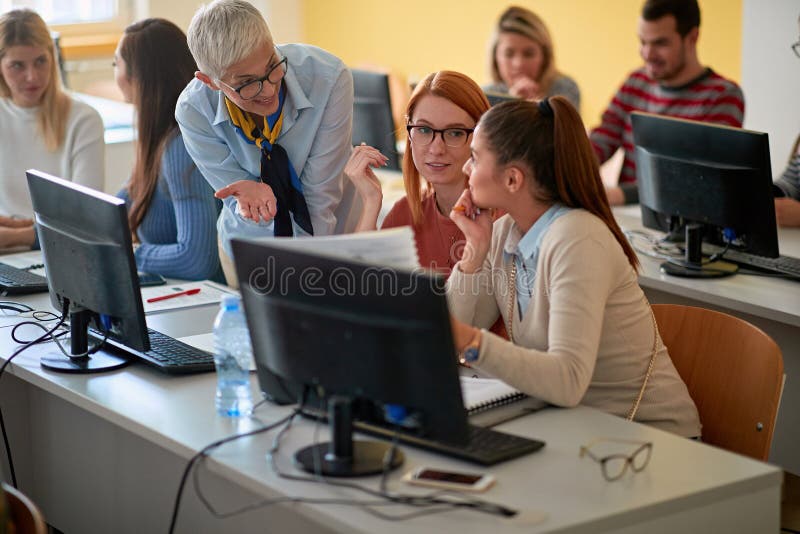 Lecturer with Girl Students Working in Computer Class on University ...