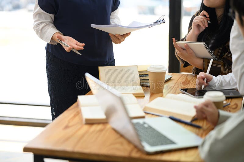 Lecturer Helping Group of Students with Project, Advising on Their Work ...