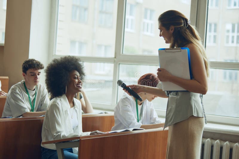 Lecturer Interacting with Students Attending Workshop. Well-lit ...