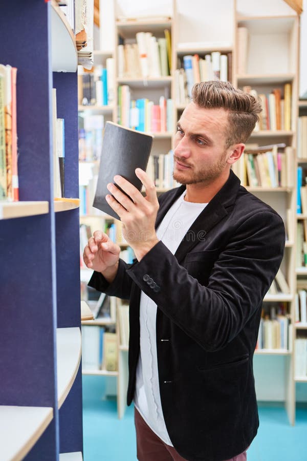 Lecturer or Librarian with Book in Front of a Shelf Stock Photo - Image ...