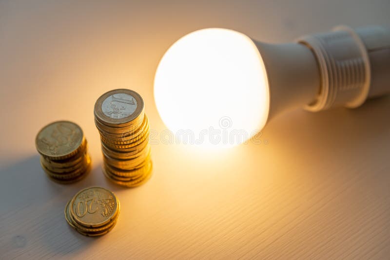Led Bulb with Coins Next To it. Stock Photo - Image of bulb, cost ...