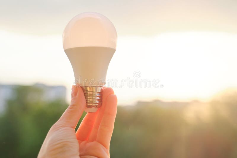 Led Bulb, Hand Holding Lamp, Evening Sunset Sky Background Stock Image ...