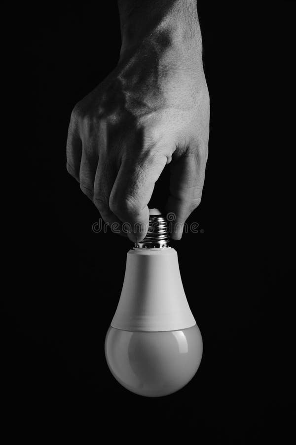 LED Eco Friendly Lamp in Hand on Black Background Stock Image - Image ...