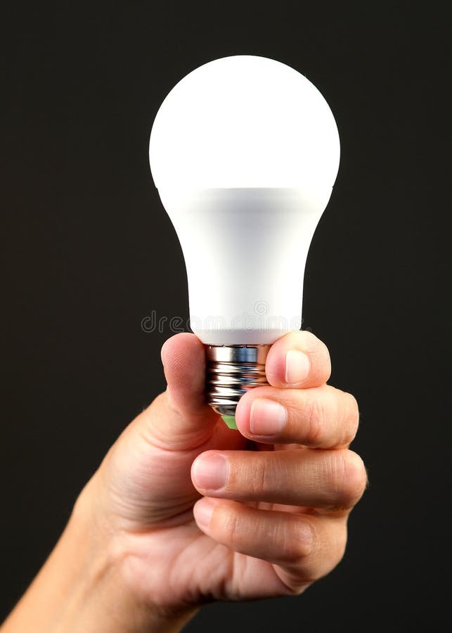 Led Energy-saving Light Bulb in the Hand of a Person. the Concept of ...