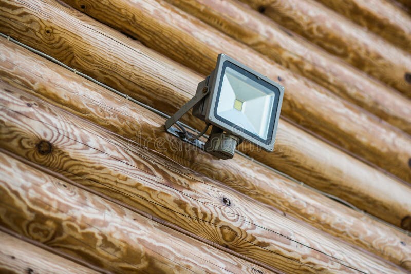LED Flashlight on a Wooden Log Wall Stock Photo - Image of retro ...