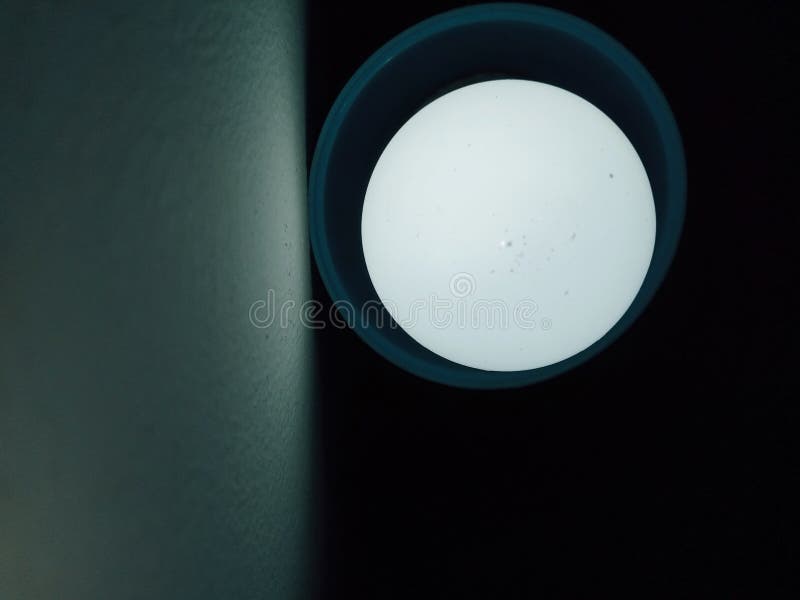 LED Light Bulb Glowing on Wall at Night Stock Photo - Image of light ...