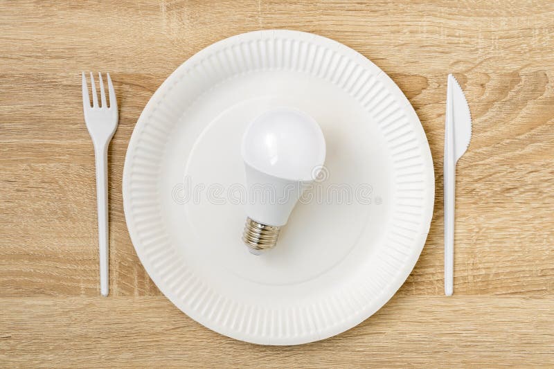 LED Light Bulb in a White Disposable Plate Stock Photo - Image of knife ...