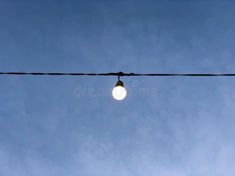 Led Light Bulb on the Wire with Blue Cloudy Sky Stock Image - Image of ...