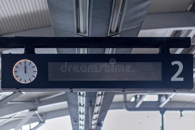 LED Panel Display with Analog Clock in the Train Station. Train ...