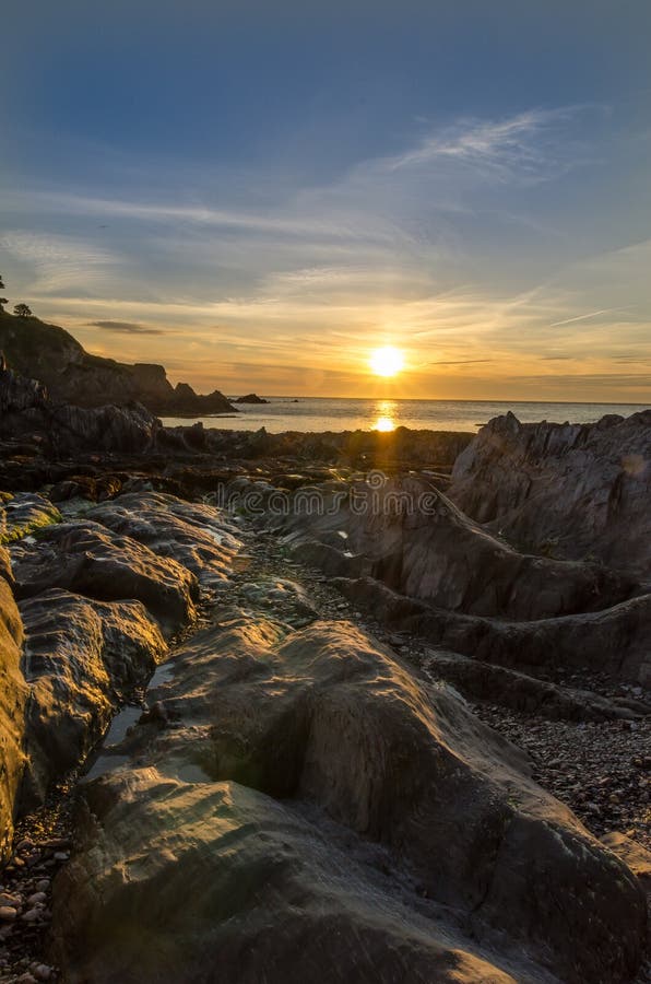 Lee Bay sunset stock photo. Image of coast, stone, rock - 42033362