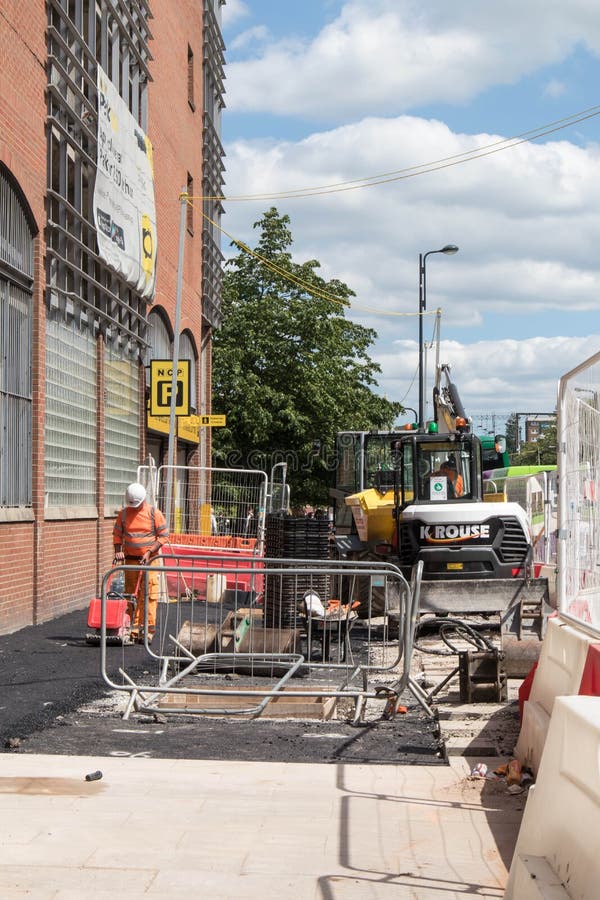Construction Work on Pavement Sidewalk with Heavy Machinery and ...