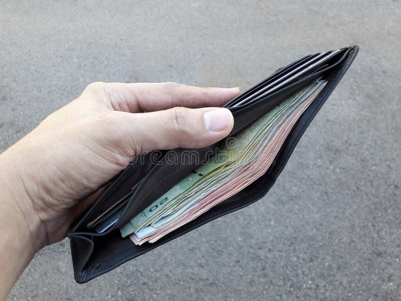 Left Hand Holding Black Leather Wallet with Full of Money Stock Photo ...