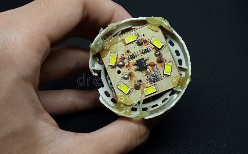 Left Hand Holding the Broken White LED Lamp, Isolated on Black ...