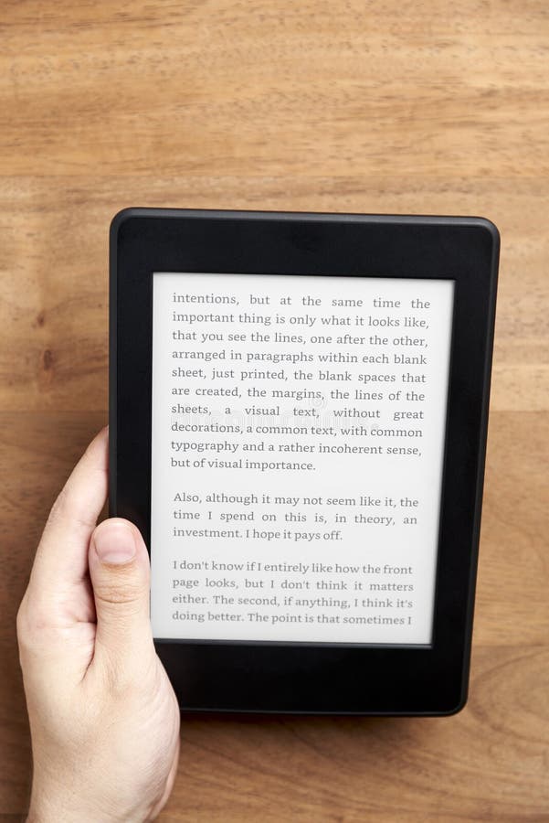 Left Hand Holding an Electronic Reader with Text on the Screen on a ...