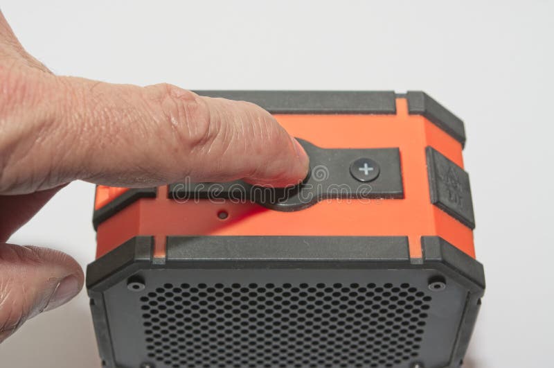 Left Hand Pressing a Power Button on a Bluetooth Speaker Stock Image ...