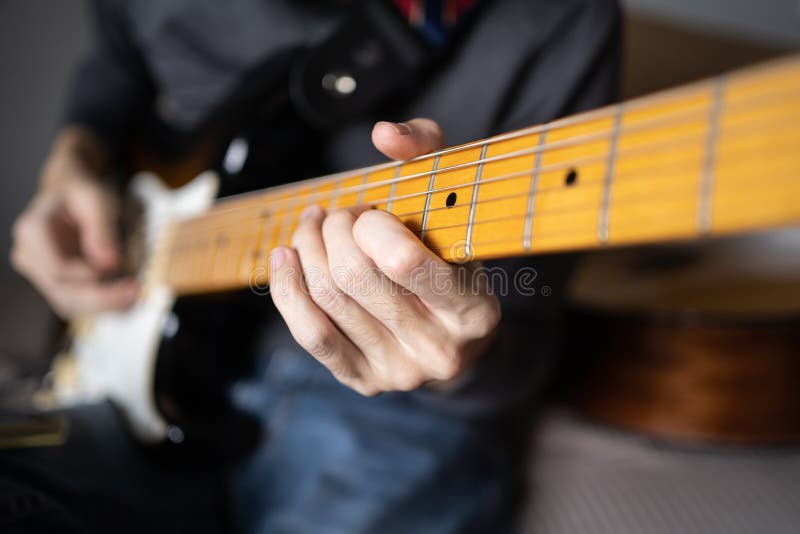 Left Hand Pressing Strings on an Electric Guitar Stock Photo - Image of ...