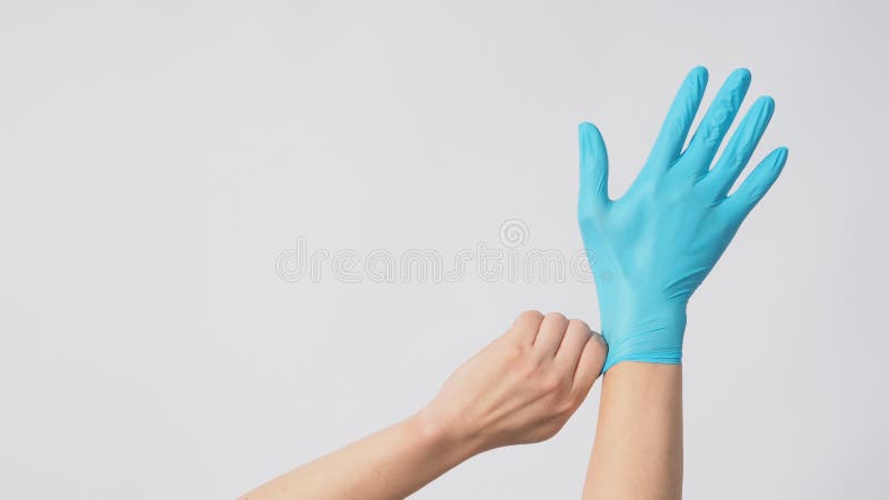 Left Hand is Pulling Right Hand with Blue Latex Gloves on White ...