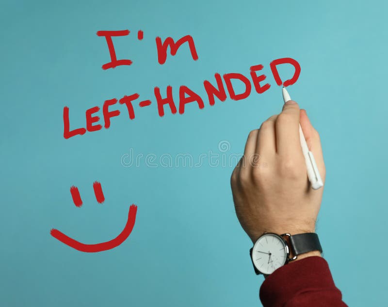 Left-handed Man Holding Pen on Blue Background, Closeup Stock Photo ...