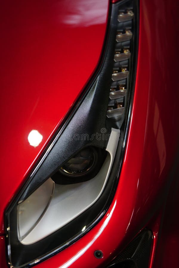 Left Headlight of a Red Sport Car Stock Image - Image of vehicle, sport ...