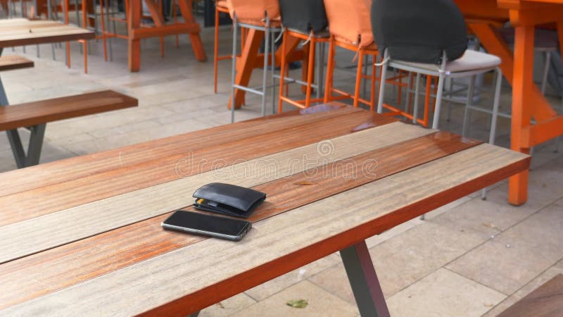 Left Wallet and Smart Phone on a Bench in the Park Stock Video - Video ...