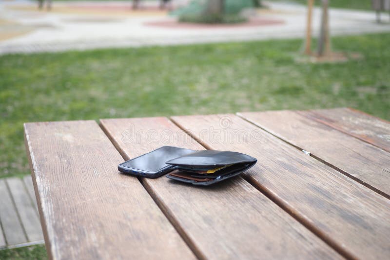 Left Wallet and Smart Phone on a Bench in the Park Stock Image - Image ...