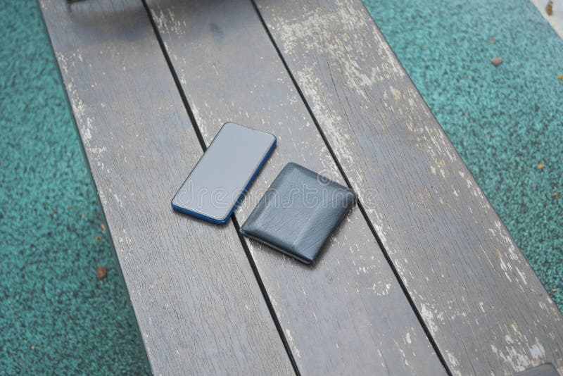 Left Wallet and Smart Phone on a Bench in the Park Stock Photo - Image ...