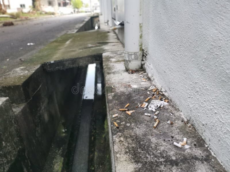 Leftover Cigarette Butts by the Corner of the Dirty Drain. Stock Photo ...