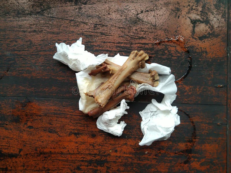 Leftover Food Waste in the Form of Chicken Bones and Tissues on a Brown ...