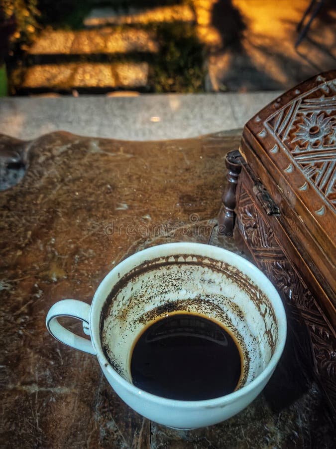 Leftover Java Coffee in Ivory White Vintage Cup on Old Wooden Table ...