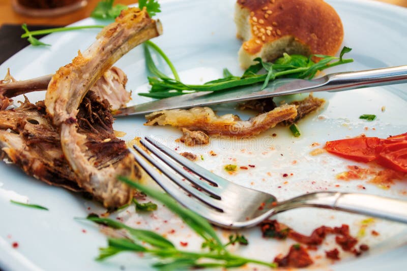 Leftovers and Cutlery in Plate on Table Stock Image - Image of ...