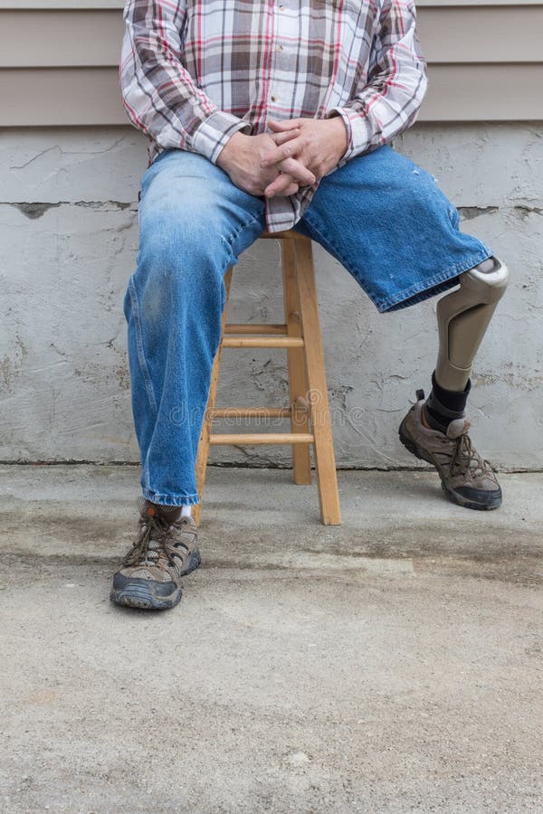 Leg Amputee Sitting on Stool with Prosthetic Leg To the Side Stock ...