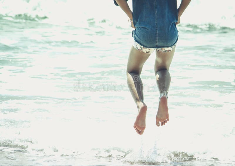Leg of Girl Jump Above the Wave on the Ocean Beach Stock Photo - Image ...