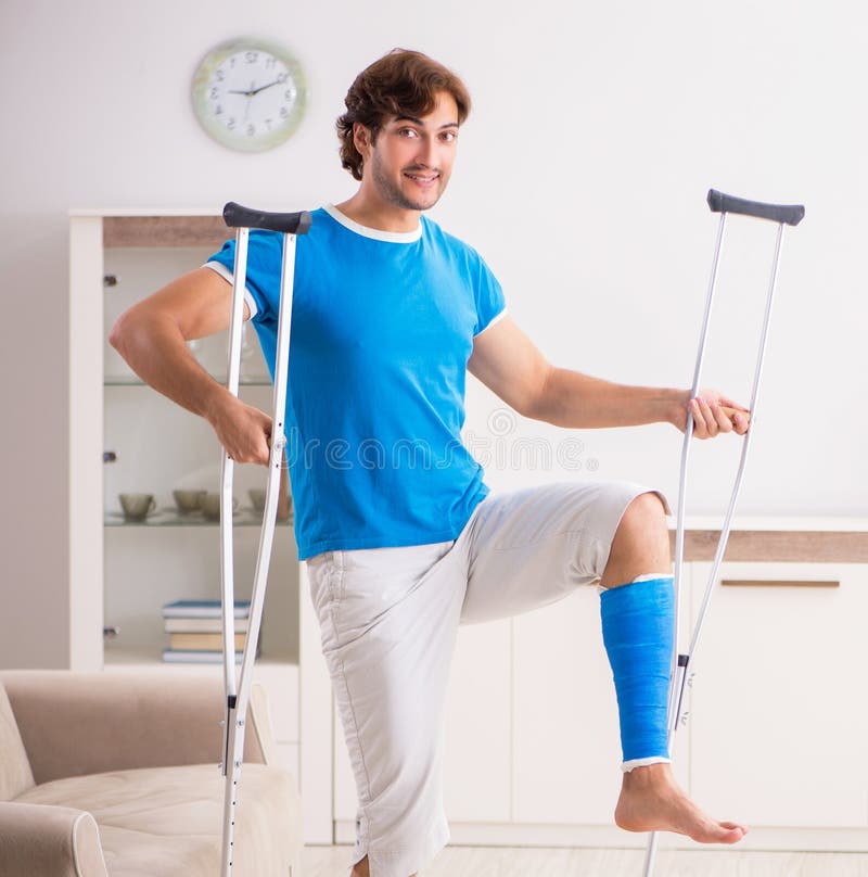 Leg Injured Young Man with Crutches at Home Stock Image - Image of ...