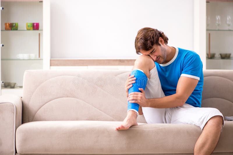 The Leg Injured Young Man on the Sofa Stock Photo - Image of frustrated ...
