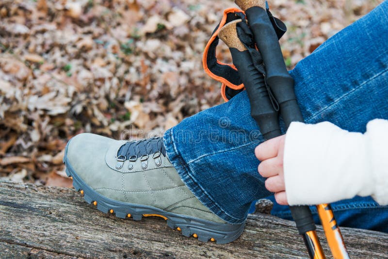 Leg in the Trekking Boot Rests on the Log. Hand Holds Trekking Poles ...