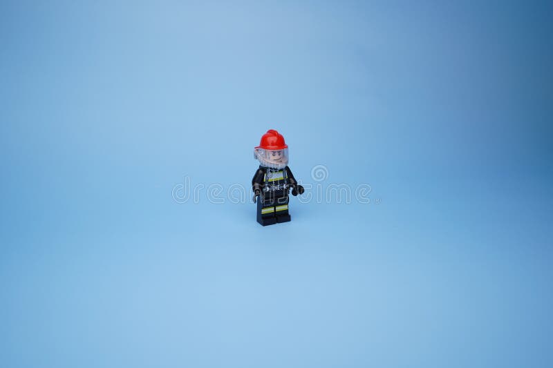 Lego Firefighter Isolated Against an Empty Blue Background Editorial ...