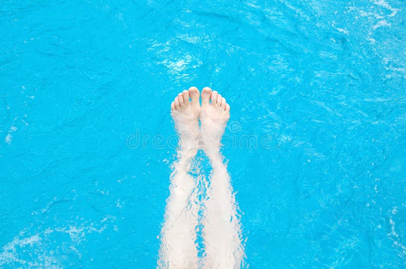 Legs on the blue water stock photo. Image of adult, hair - 23836772