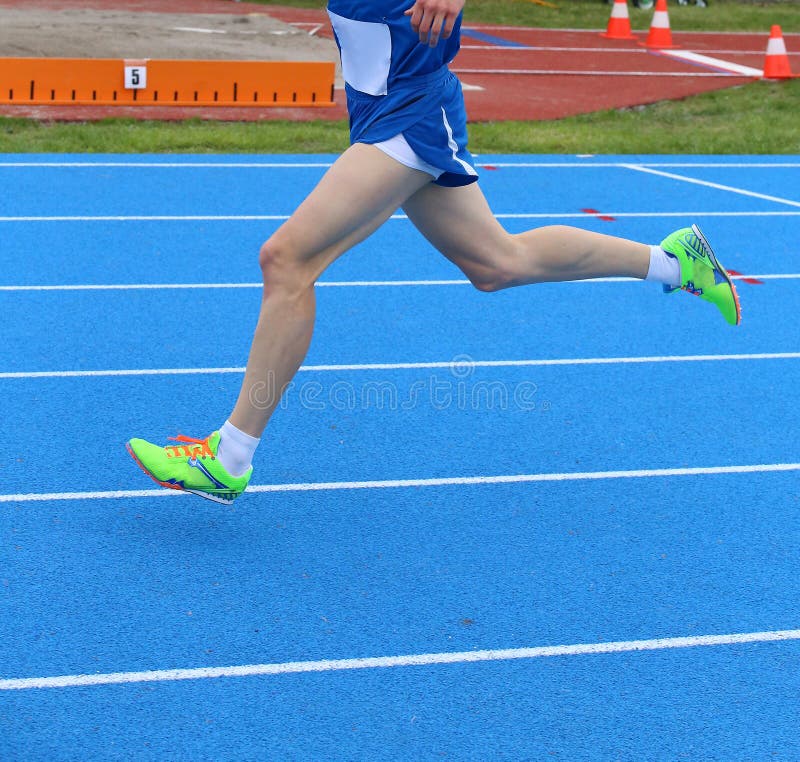 Legs of Fast Runner Runs into the Blue in Athletics Track Stock Image ...