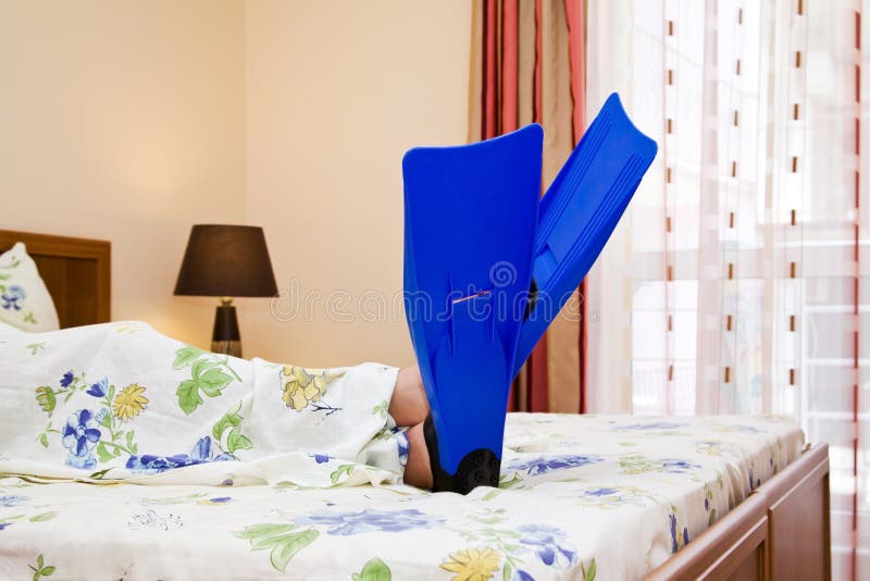 Legs in flippers on bed stock photo. Image of lighting - 61491928