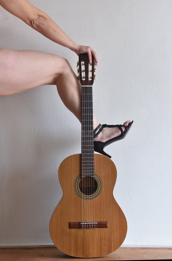 Legs and guitar, woman stock image. Image of detail - 118863445