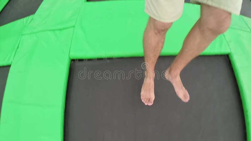 Legs of Man Jumping in Black Squares in Trampoline Stock Footage ...