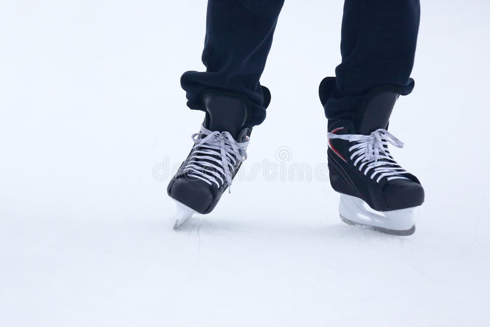 Legs of a Man Rolling on Skates on the Ice Rink Stock Image - Image of ...