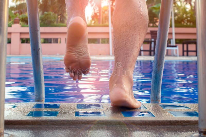 The Legs of Man Running and Jumping in Swimming Pool with Light Flare ...