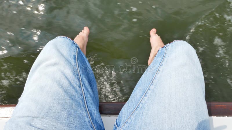 Legs of a Man Sitting on Bow of the Boat or Yacht Stock Video - Video ...