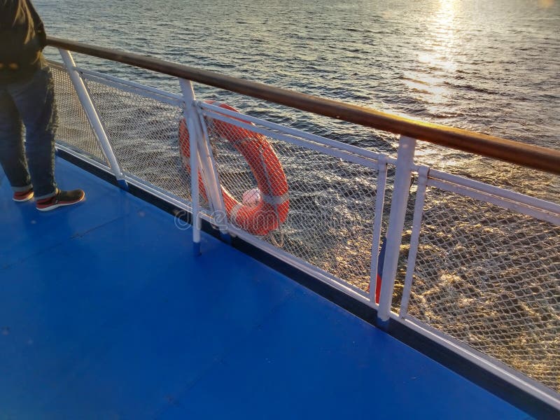 The Legs of a Man Standing on the Deck of a Ship Near the Side Stock ...