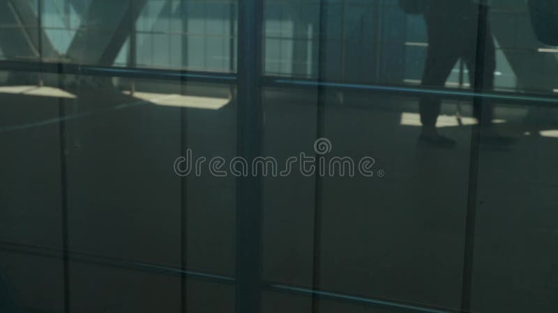 Legs of Metro Commuters Walking in Bridge. View through the Window ...