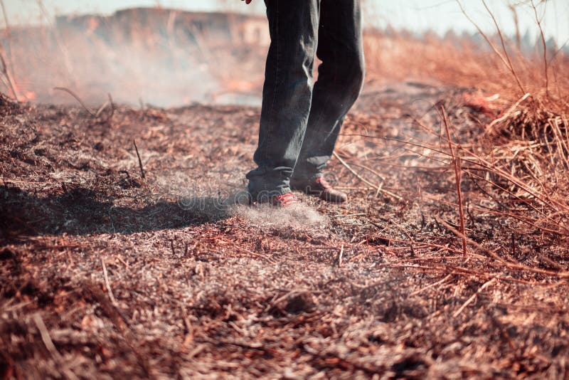 Legs of the Person Extinguish Fire. Stock Image - Image of autumn ...