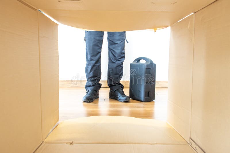 Legs of a Serviceman with Toolbox by the Open Paper Box Stock Photo ...