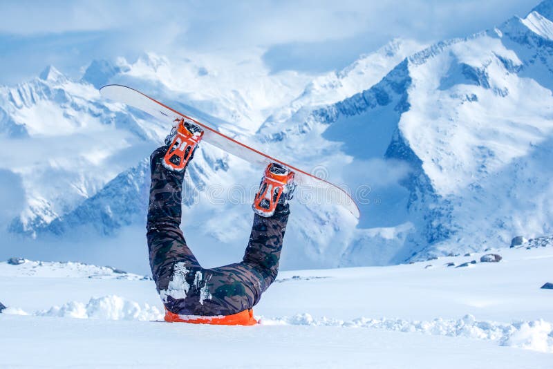 Legs of a Snowboarder Stuck in Snow Stock Image - Image of orange ...