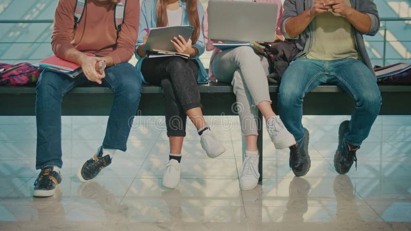 Back View of Students Sitting on Bench in the University HallWay during ...